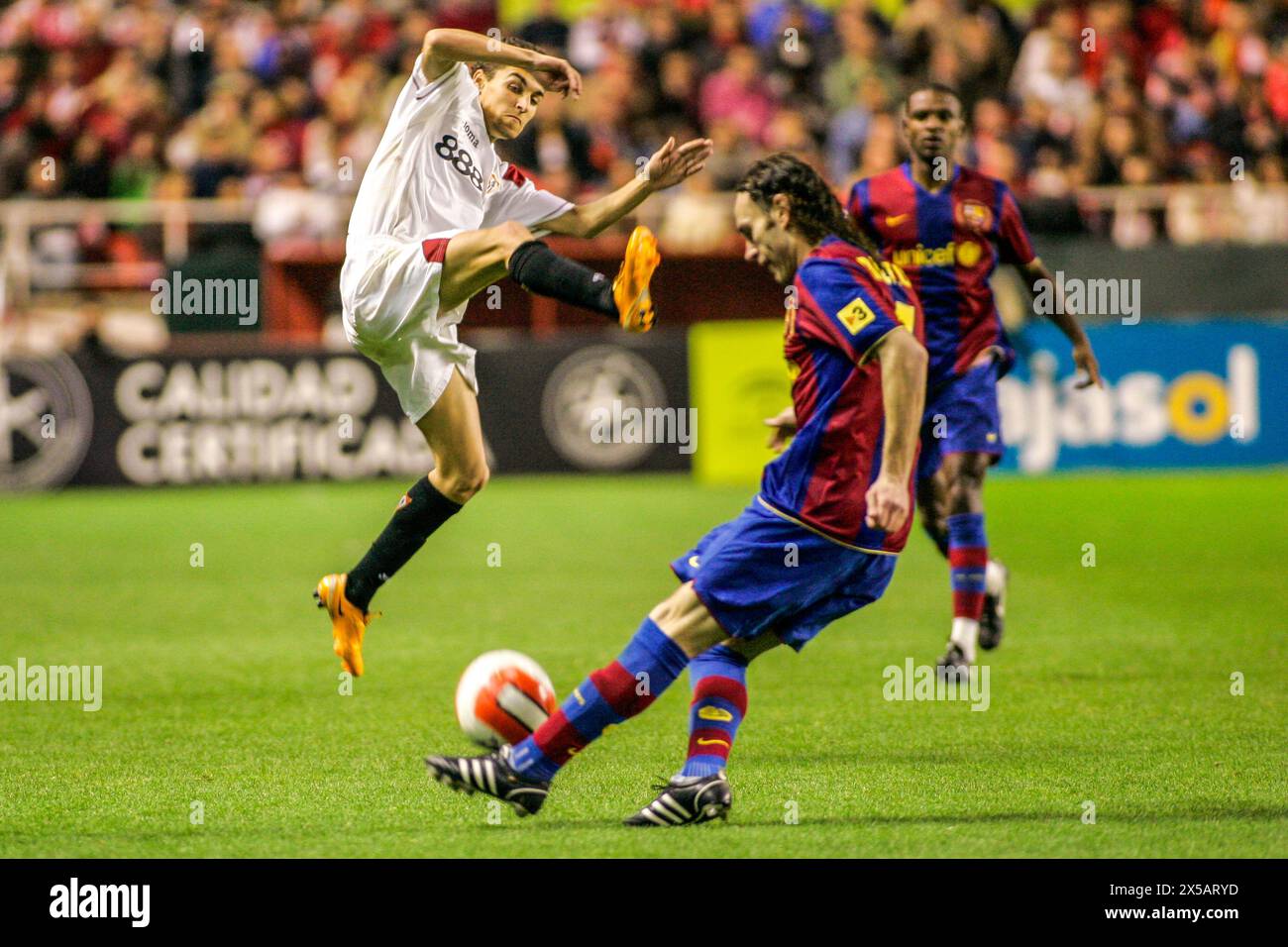 Jesus Navas executes an acrobatic jump to evade Milito in a Sevilla ...