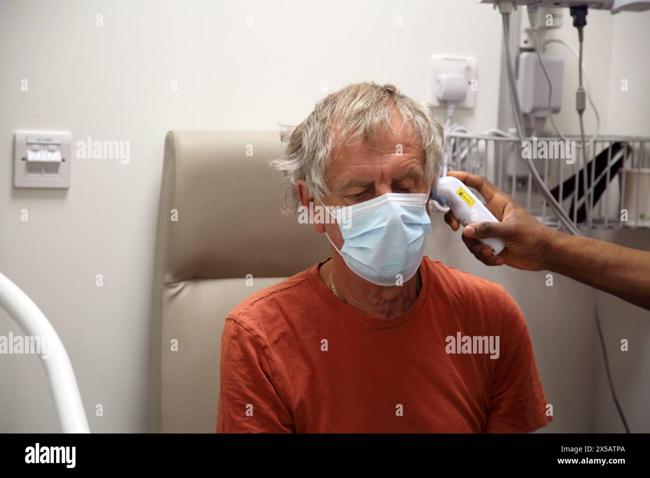Nurse Taking Temperature of Cancer Patient with Tympanic thermometer ...