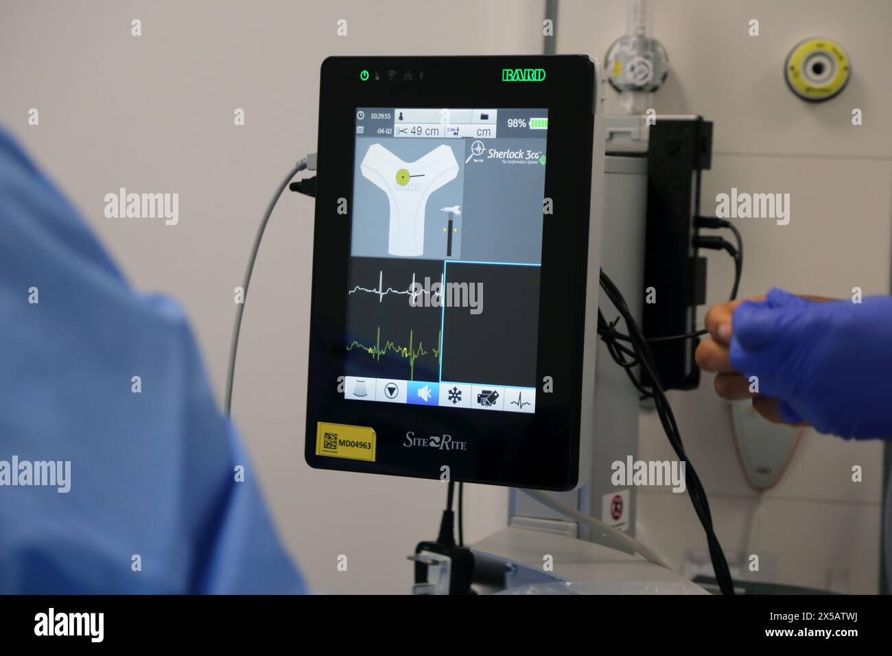 Nurse Watching Monitor while Administering Peripherally Inserted ...
