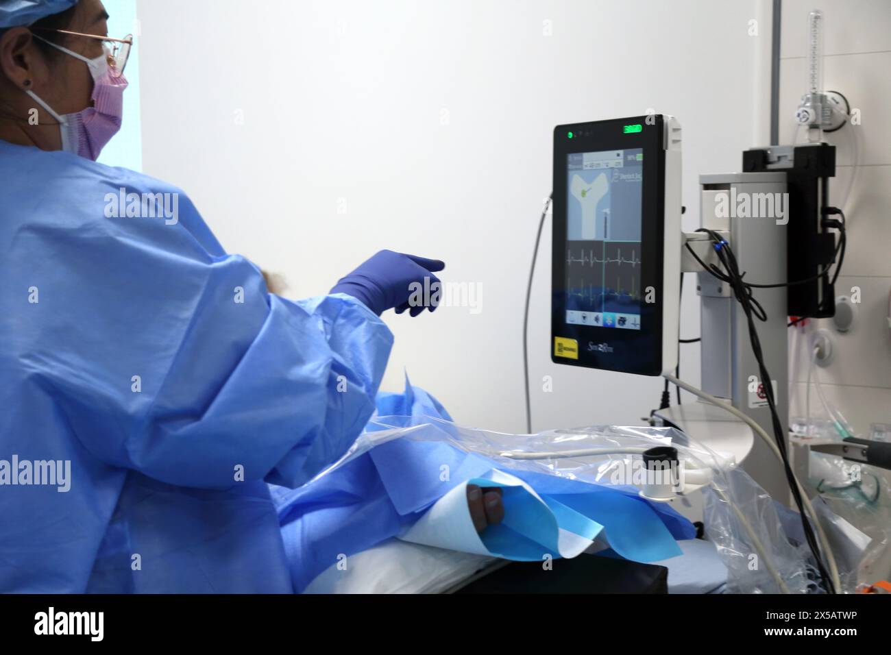 Nurse Watching Monitor while AdministeringPeripherally Inserted Central ...