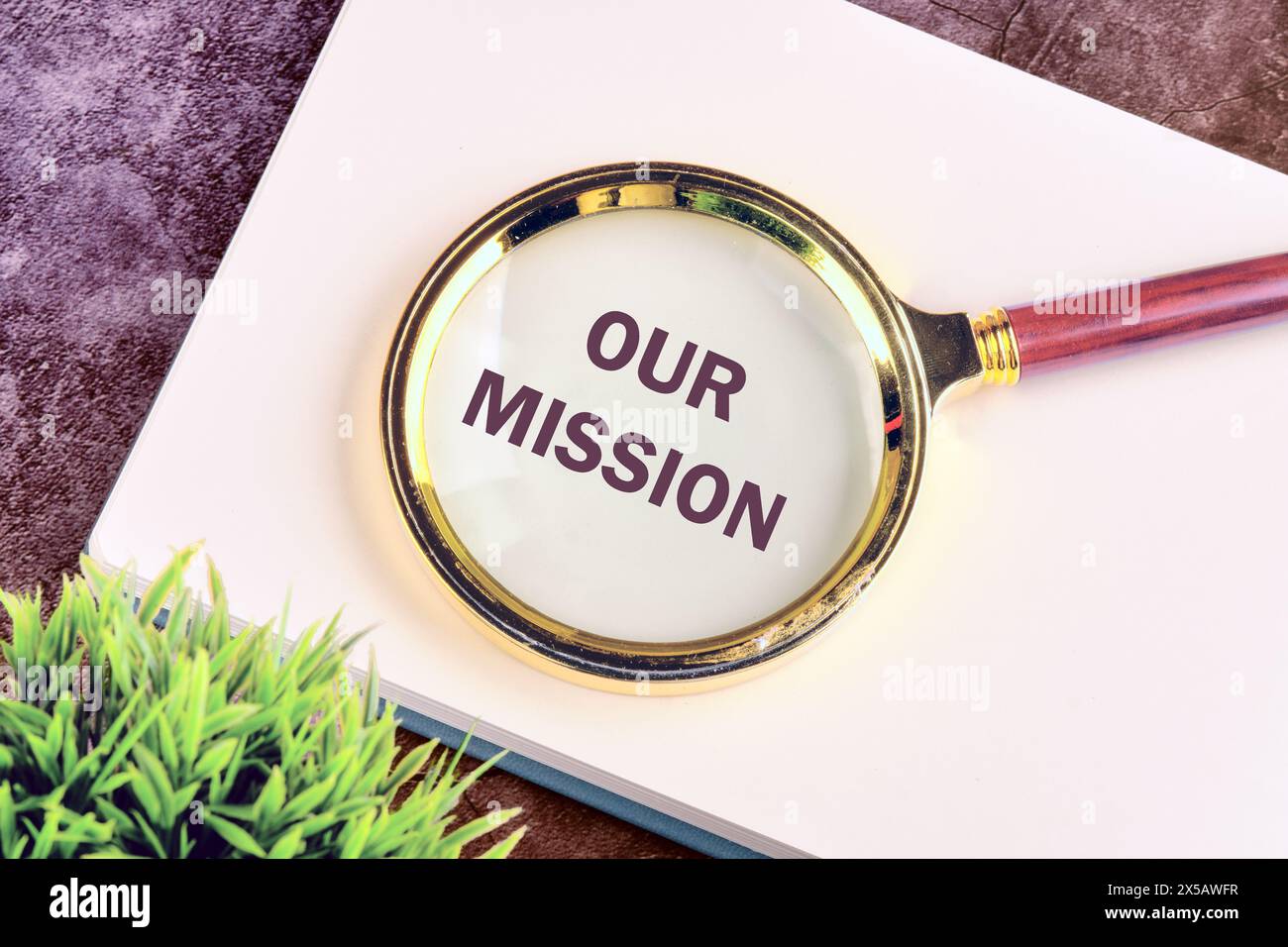 Our Mission symbol. Concept word Our Mission through a magnifying glass ...