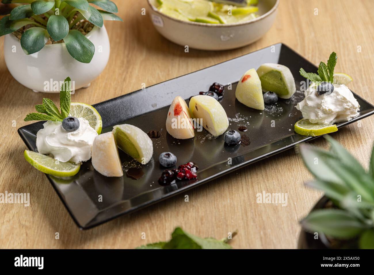 Gourmet Asian dessert platter with whipped cream. Mochi whit ice cream ...