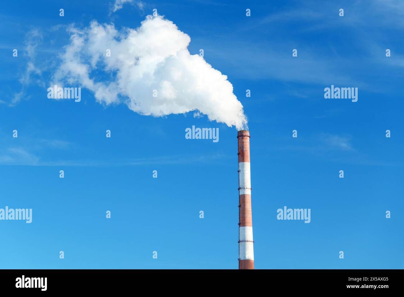 Smokestack emits thick creating a striking visual image of industrial ...