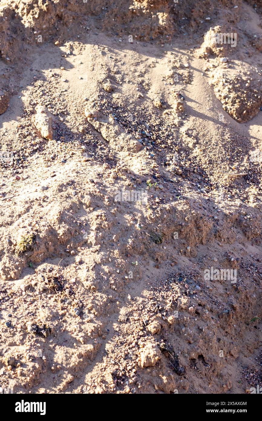 A mixture of soil, brown bedrock, and small rocks resembling a mini ...