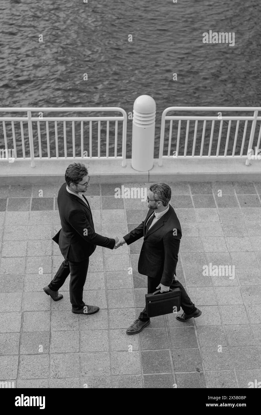 Business man shaking hands. Two businessmen handshake outdoor ...