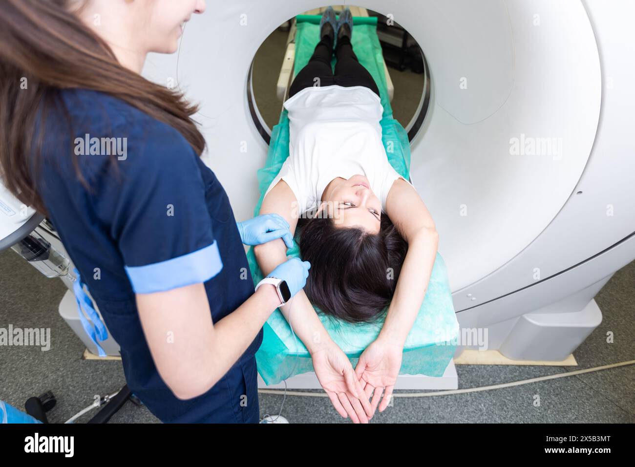 Pretty, young woman goiing through a Computerized Axial Tomography CAT ...