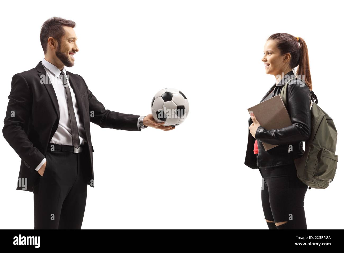 Man in a suit giving soccer ball to a female student isolated on white ...