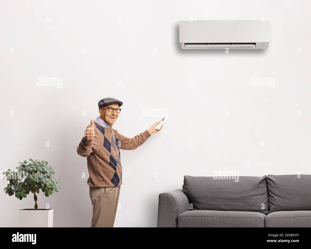 Elderly man putting on AC unit on with a remote controller and ...
