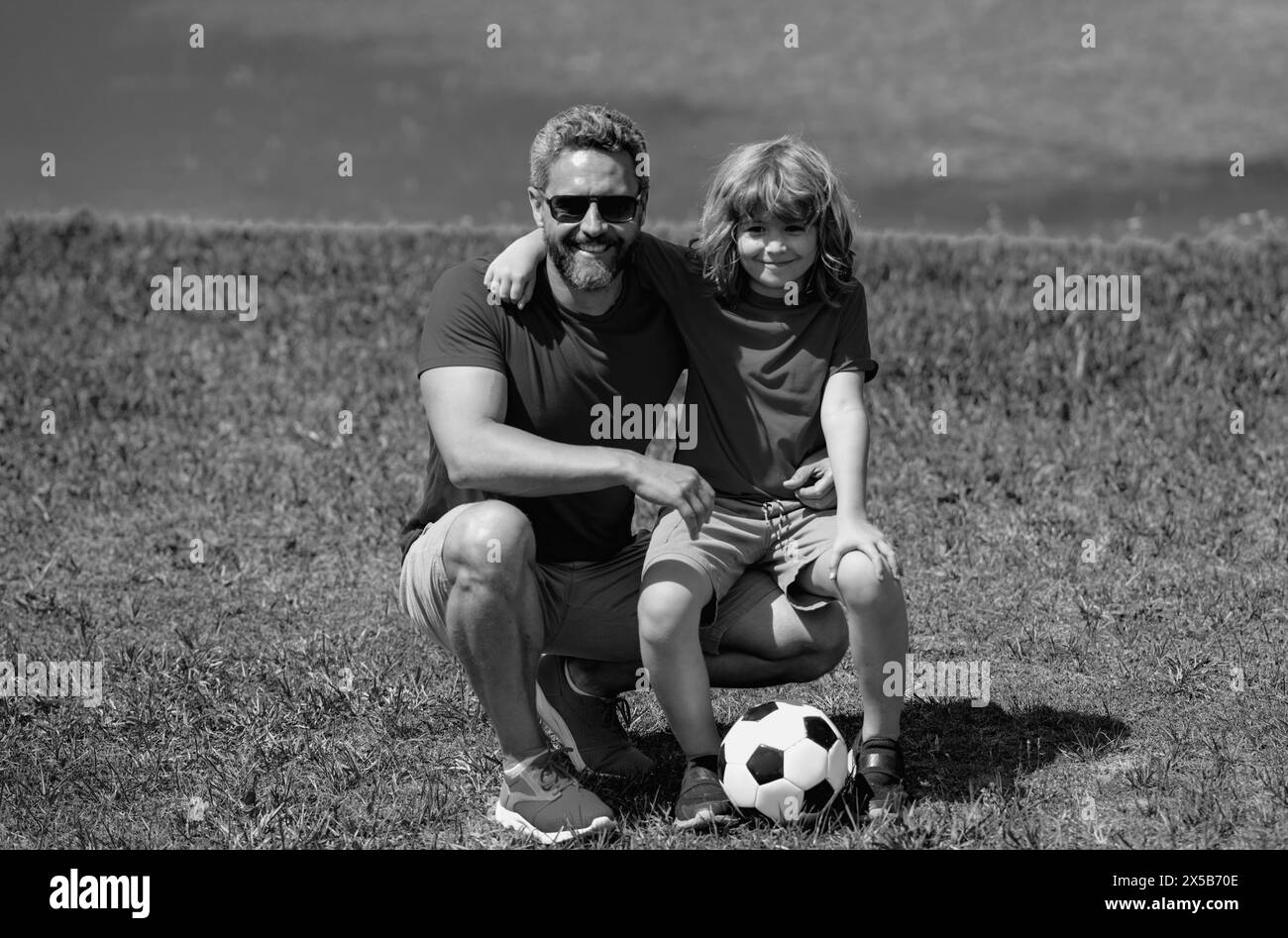 Excited father with son football team winning. Dad and little boy play ...