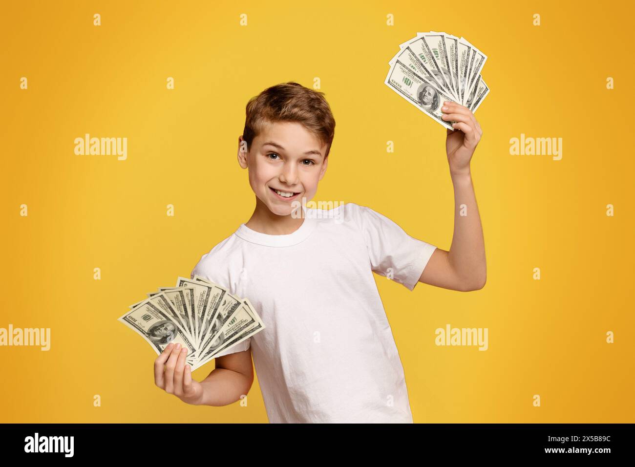 Happy teen boy holding bunch of money Stock Photo - Alamy