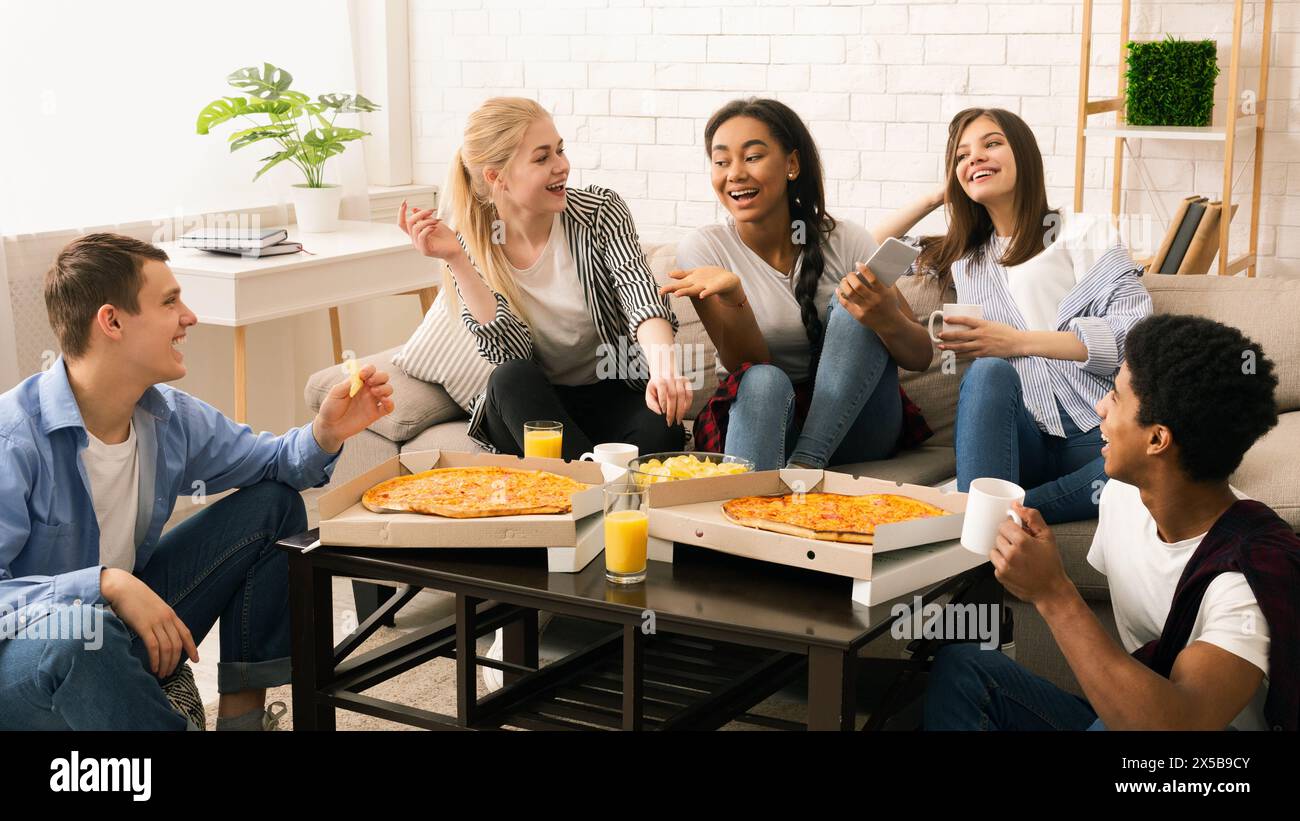 Group of Teenagers Sitting Around a Table Eating Pizza Stock Photo - Alamy