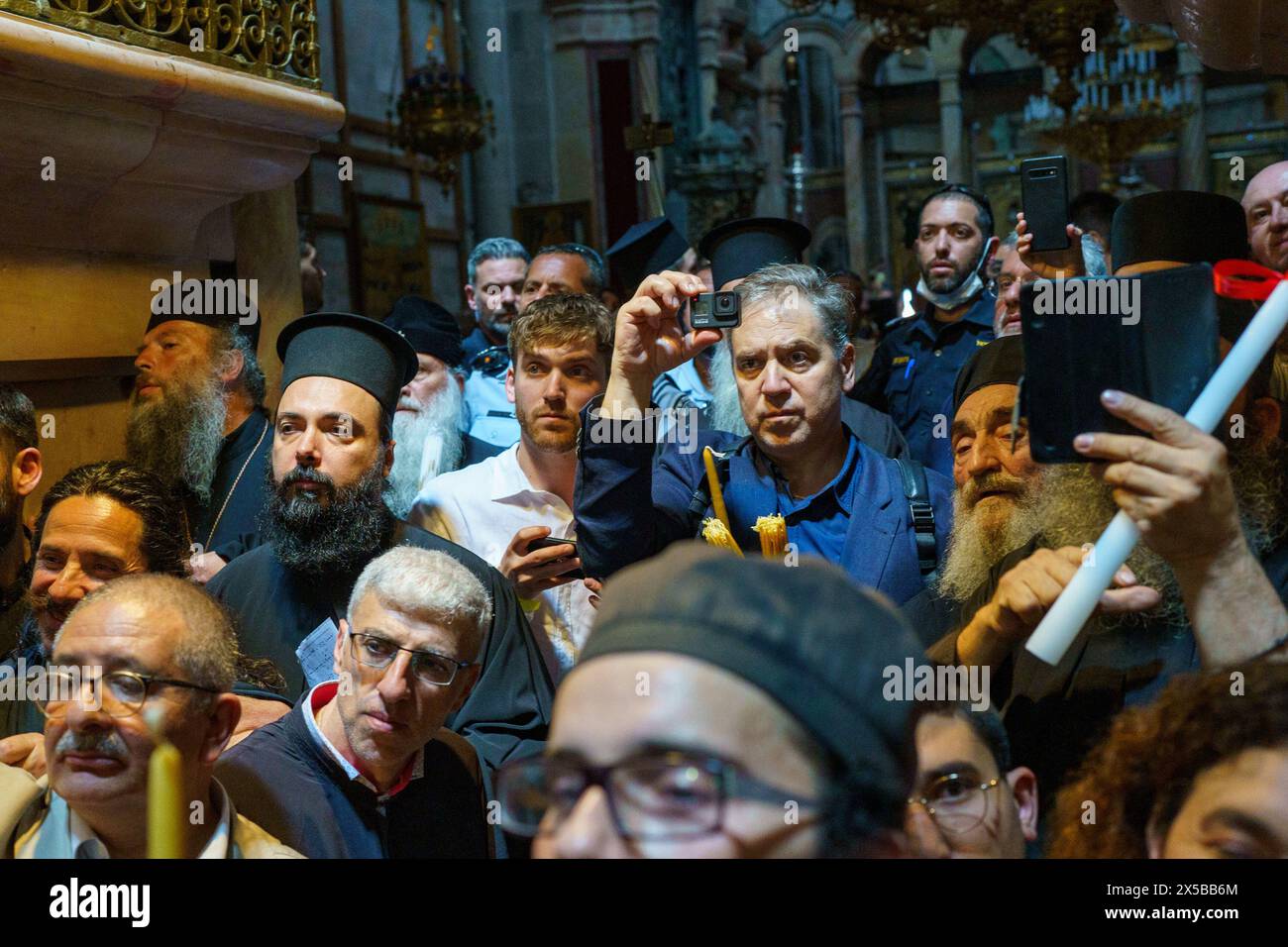 Devotees await for the Patriarch to come out from the aediculae with ...