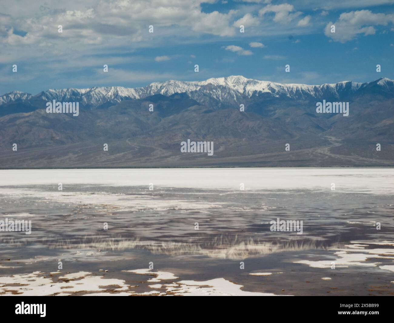 person at the Bad Water Basin salt flats looking at where Lake Manly ...