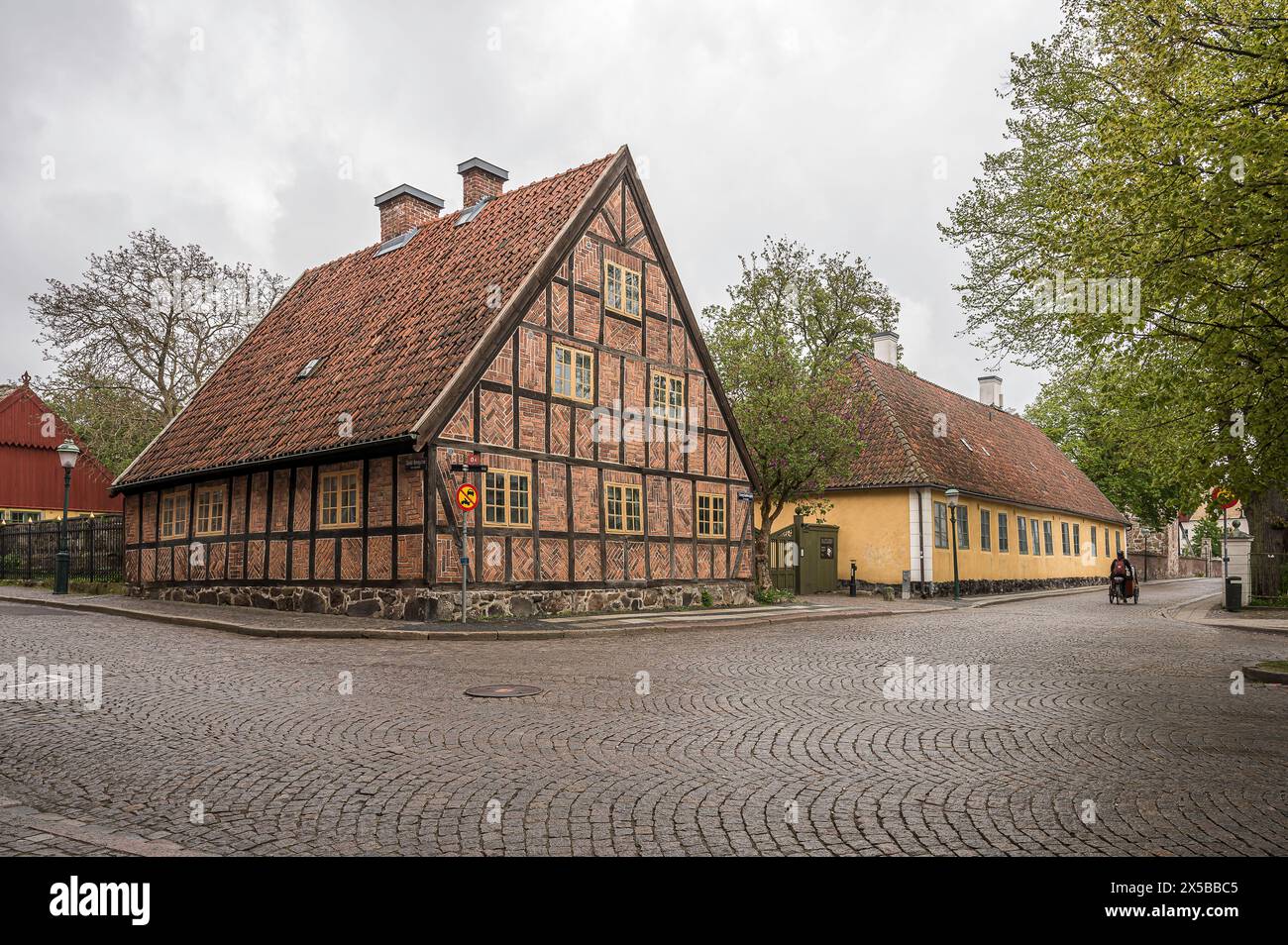 half-timbered red brick-house on a cobblesone street in Lund, Sweden ...