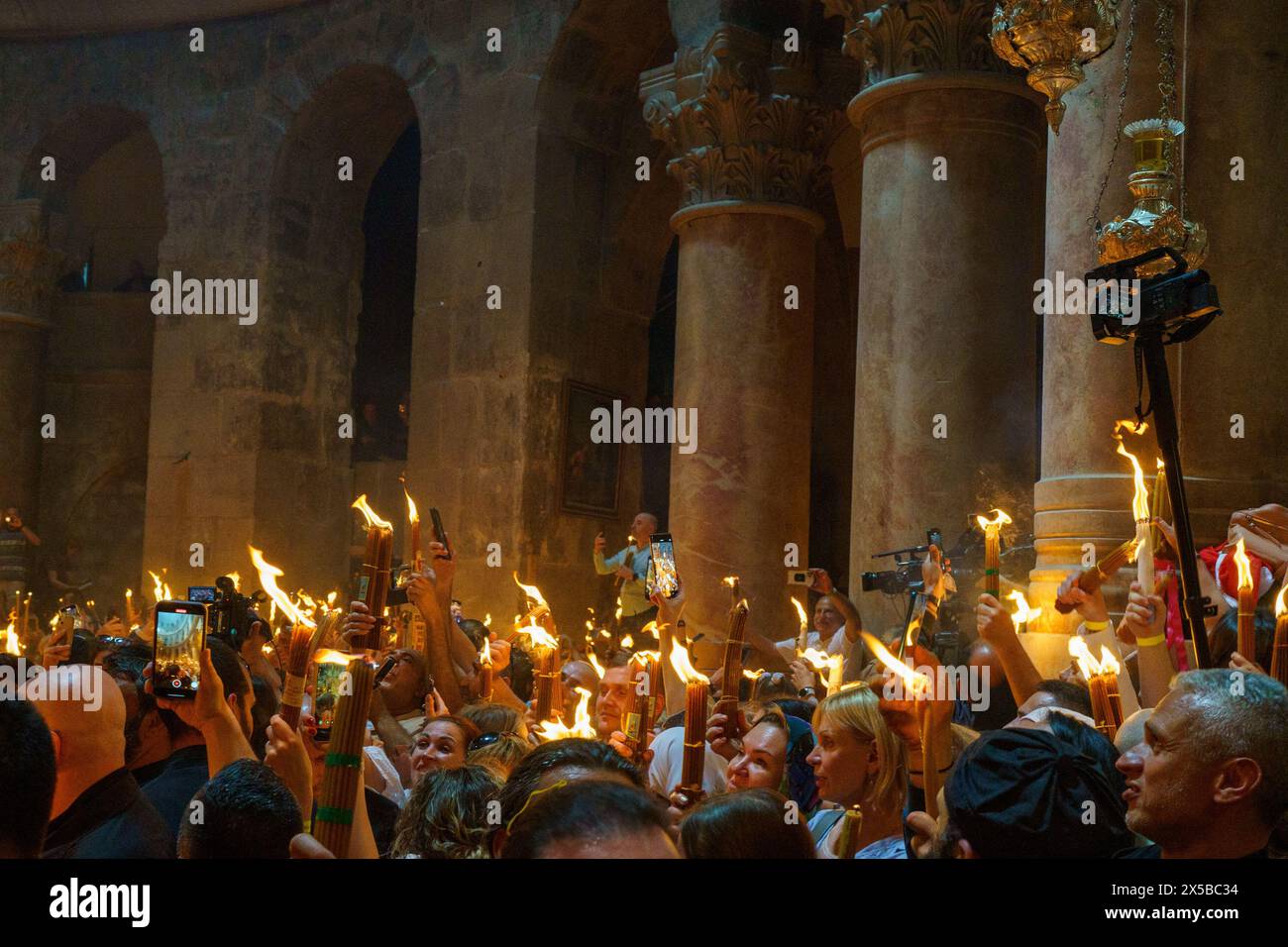 The Holy Fire is shared between the devotees from candle to candle and soon the church is full ...