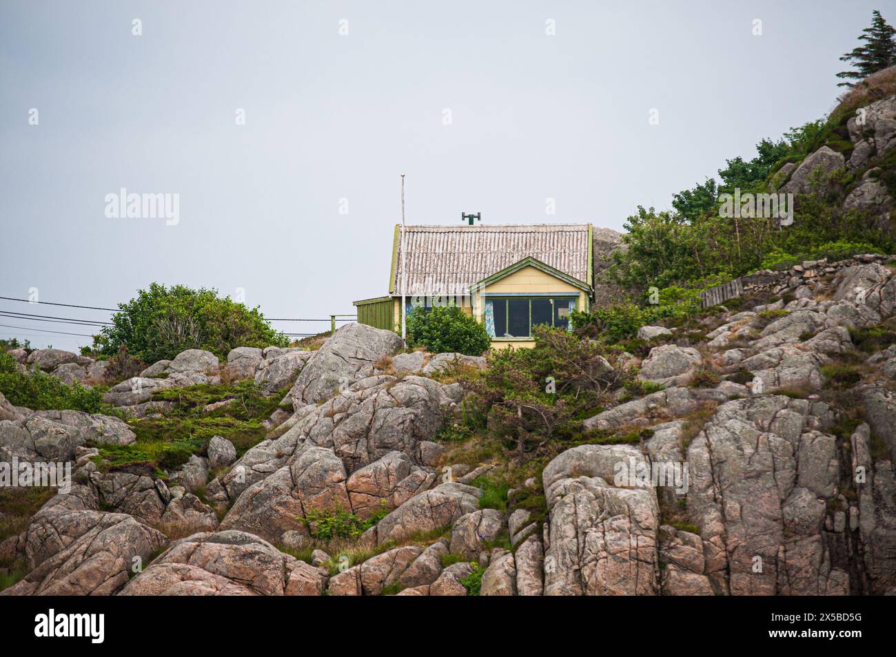 Small old yellow hut by the sea Stock Photo - Alamy