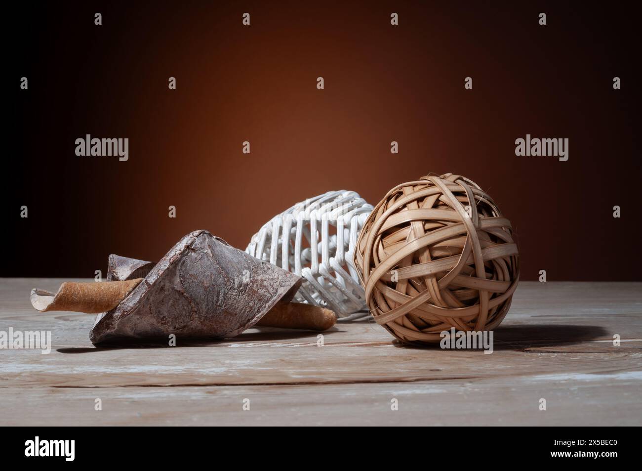 decorative objects made of wood and wicker, on a muted gradient ...