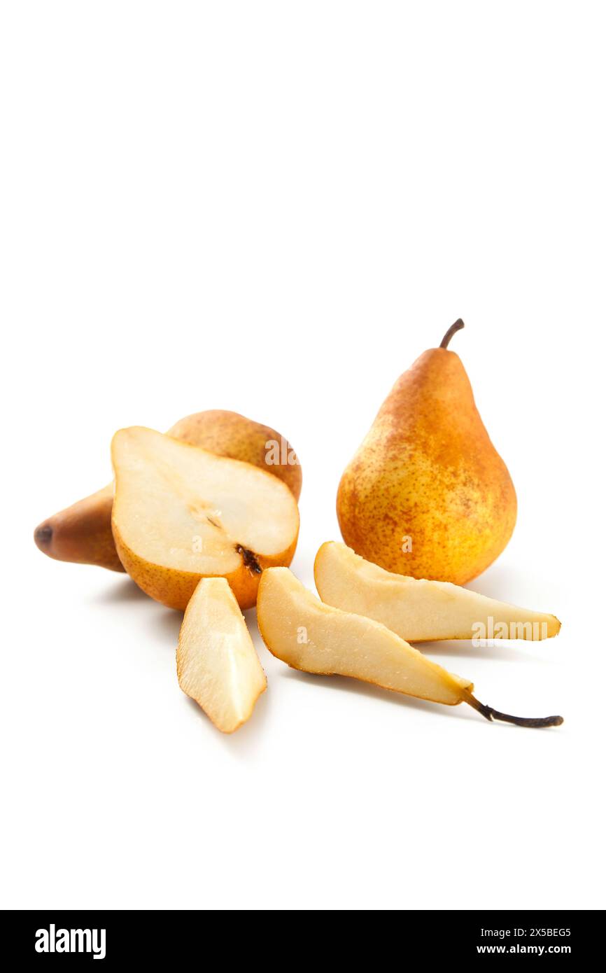 Two whole, half and slices of ripe juicy pear fruit with soft shadow ...