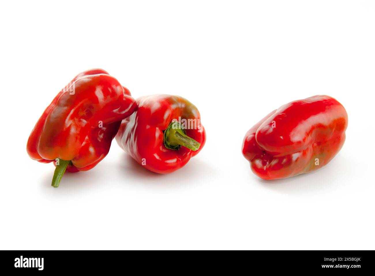 Three whole red bell pepper (capsicum) known as sweet bell pepper ...