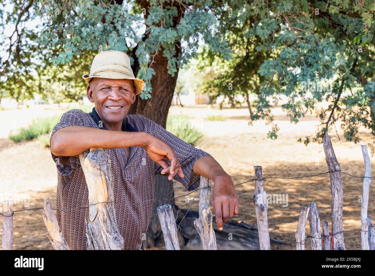 African village, happy single old man with toothy smile behind the ...