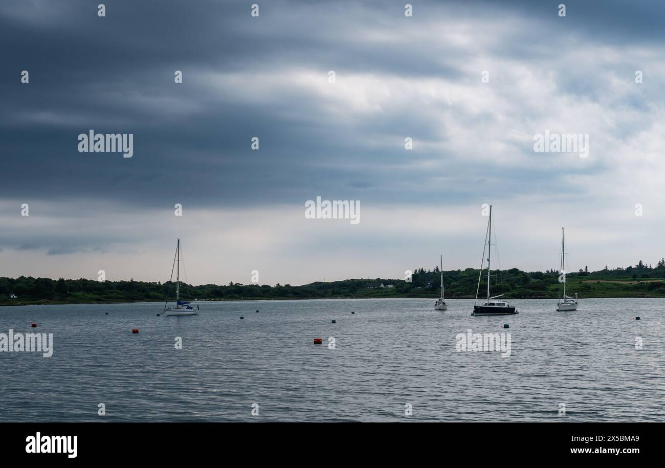 Sailing boats moored in the bay on Isle of Gigha, Scotland, sheltering ...