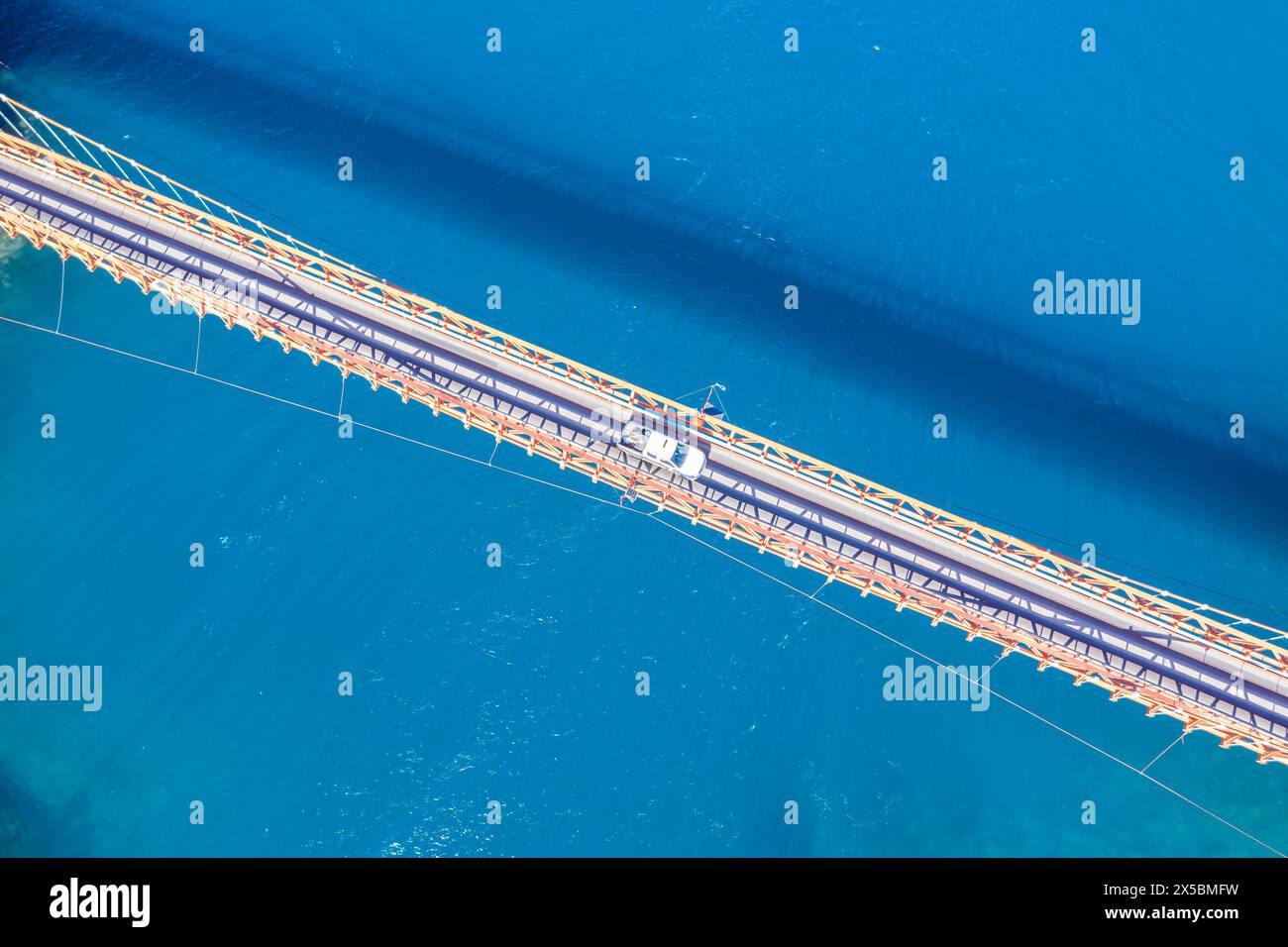 Aerial view of suspension bridge Puente General Carrera, top-down view ...