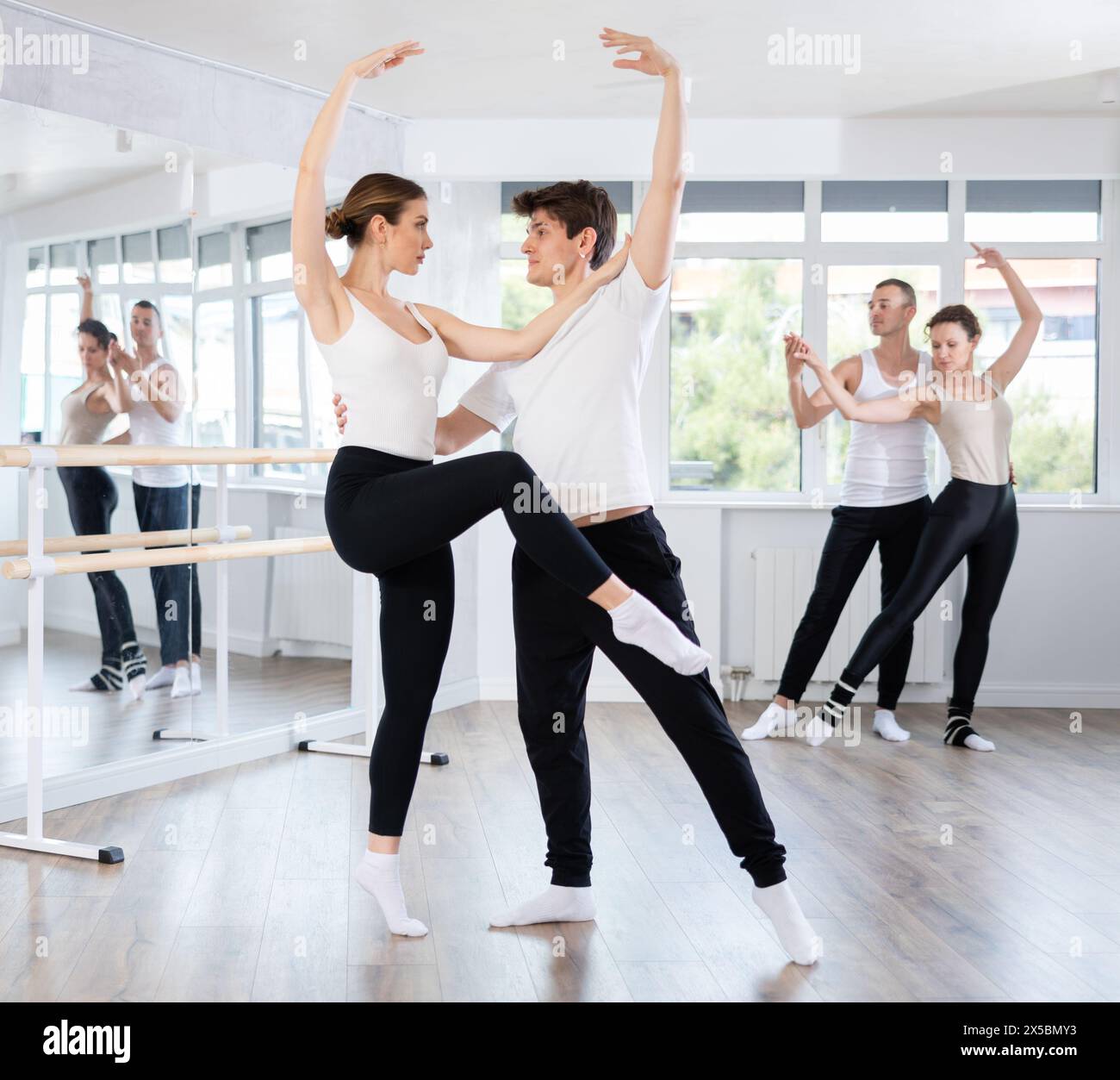 Happy smiling woman dressed in black and white sportswear enjoying ...