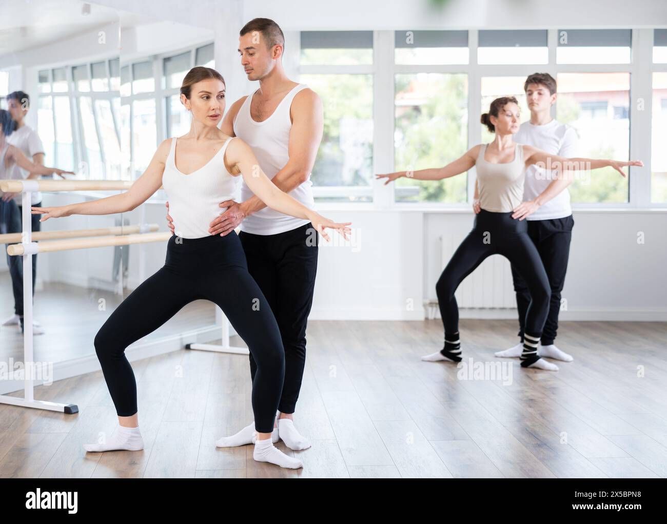 Positive ballet dancers couple performing graceful choreography ...