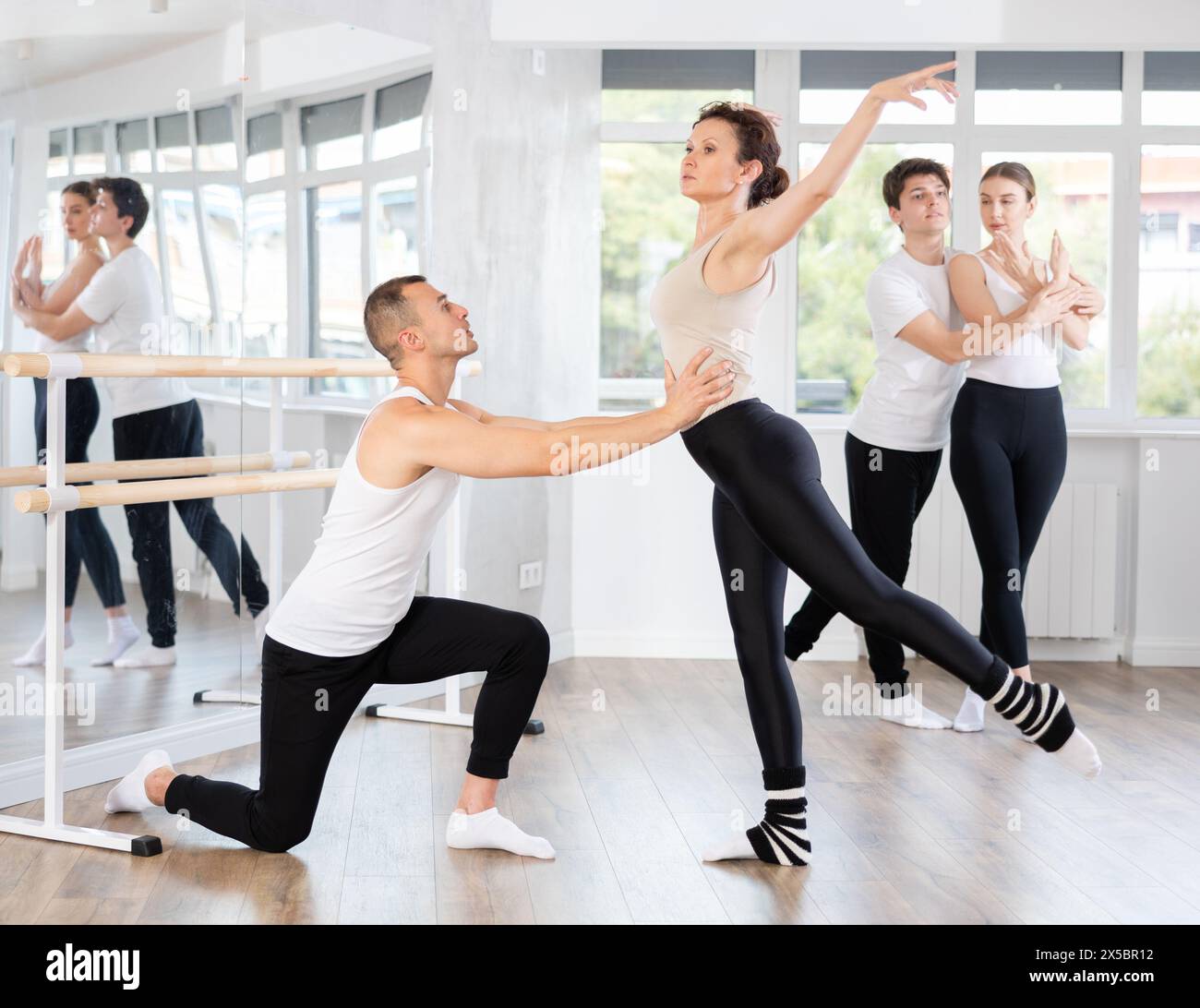 Young man and adult woman rehearsing pair ballet Stock Photo - Alamy