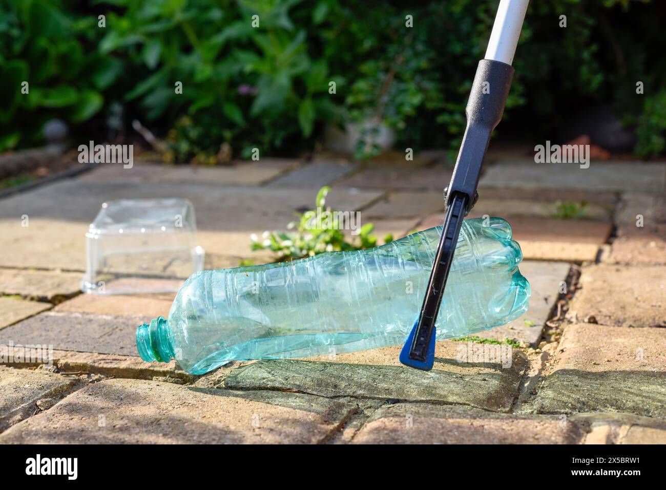 Picking up plastic waste and rubbish which has been dropped on the ...