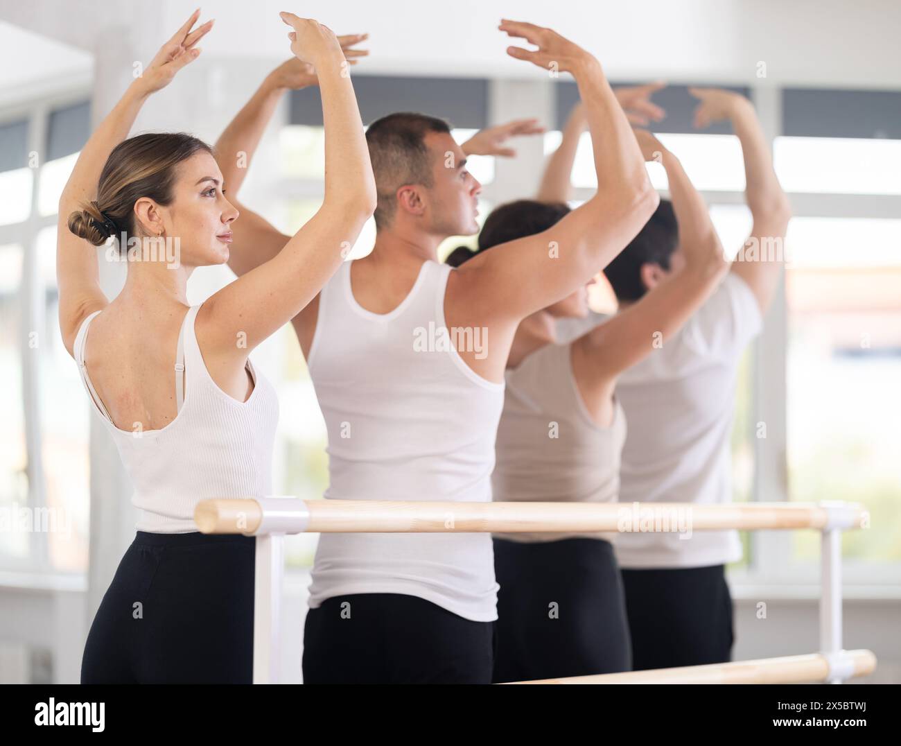 Group of dancers stand in fifth position at barre Stock Photo - Alamy