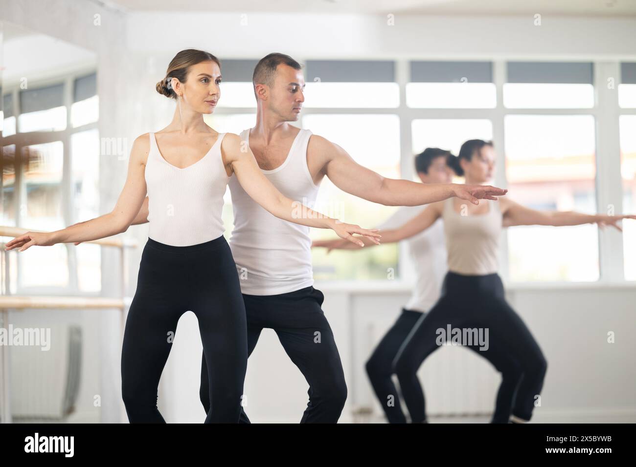 Positive ballet dancers couple performing graceful choreography ...