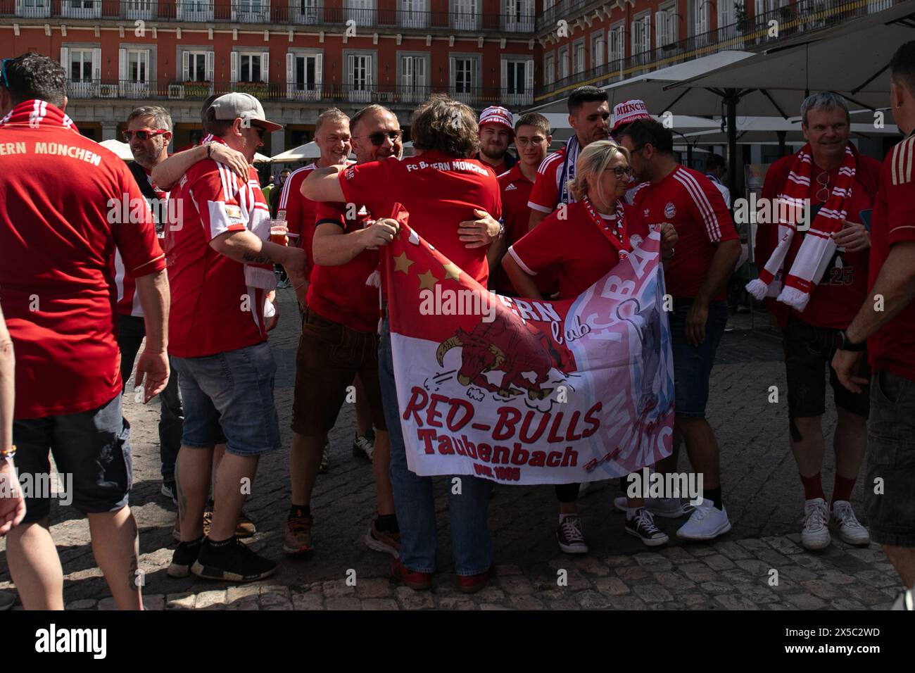 A group of fans of the German club Bayern Munich hug each other in ...