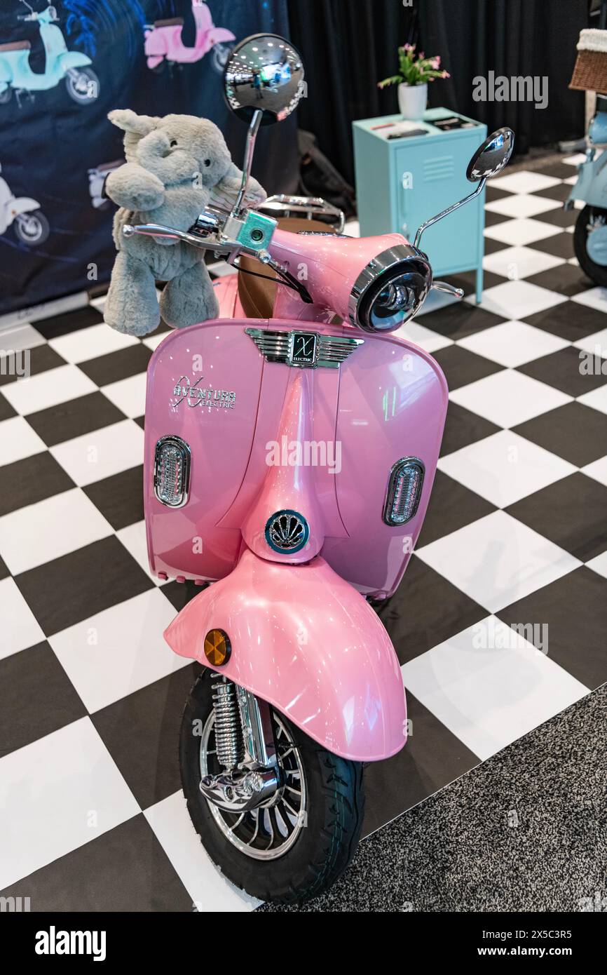 New York City, USA - March 27, 2024: Retro Aventura-X Electric Scooter Vespa style pink color at ...
