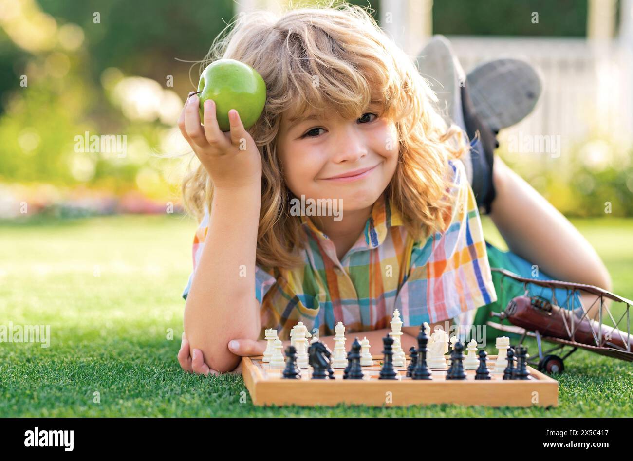 Little kid play chess in park. Child boy playing board game outdoor ...