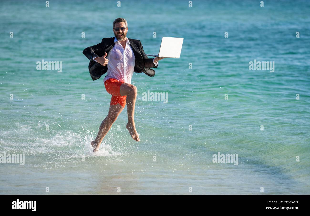 Businessman director running at the beach. director is very ambitious ...