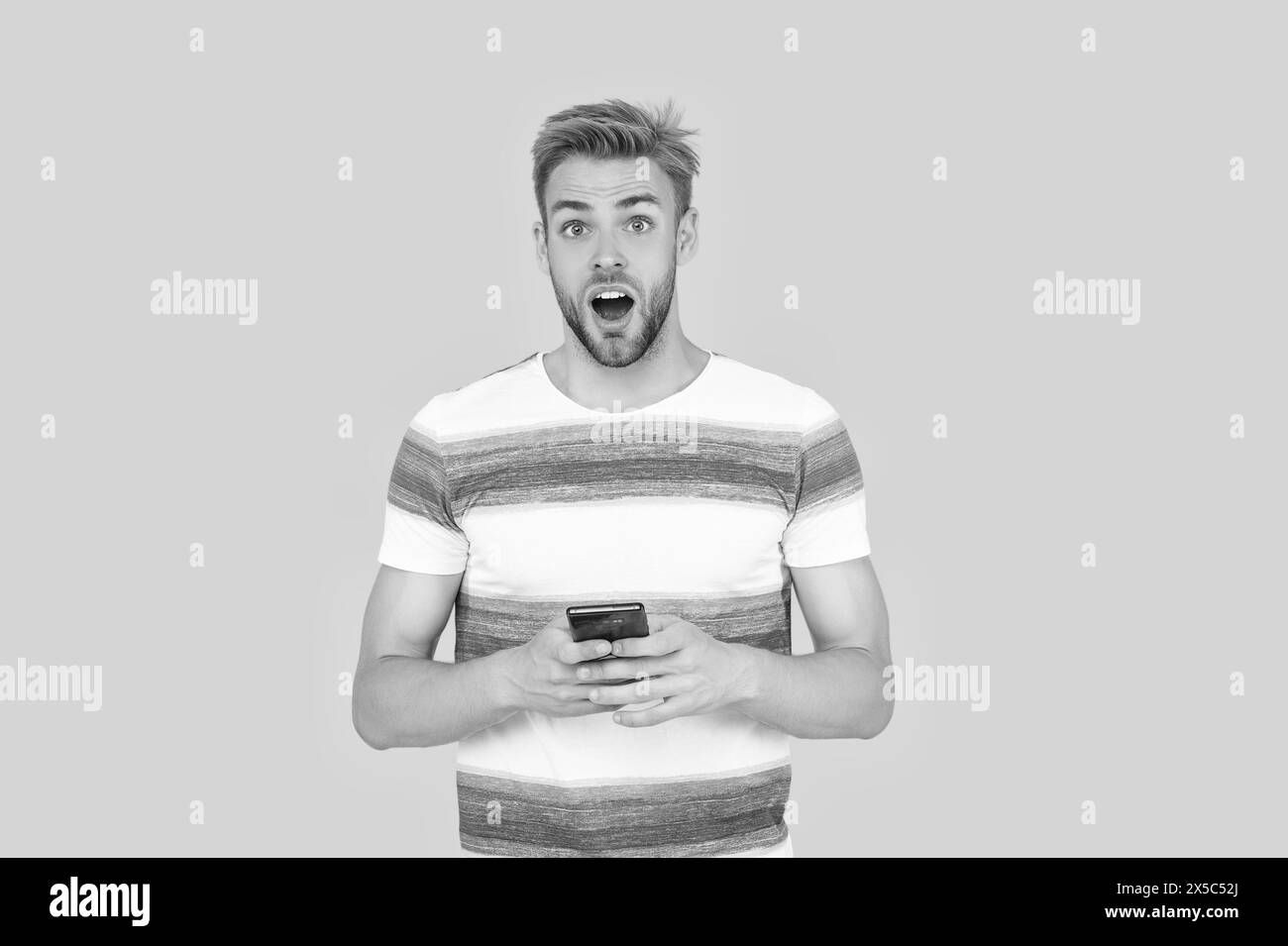 Shocked Man Uses His Phone To Text Or Message Making Communication Convenient Man Uses Phone To