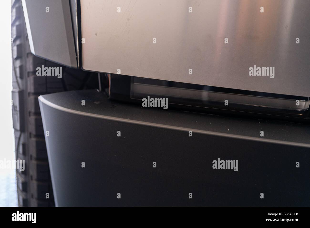 Close-Up View of the Tesla Cybertruck Side Panel and Tire Stock Photo ...