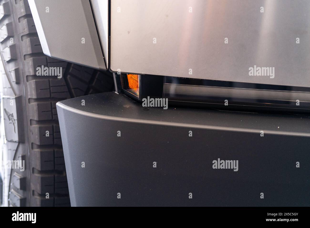 Close-Up View of the Tesla Cybertruck Side Panel and Tire Stock Photo ...