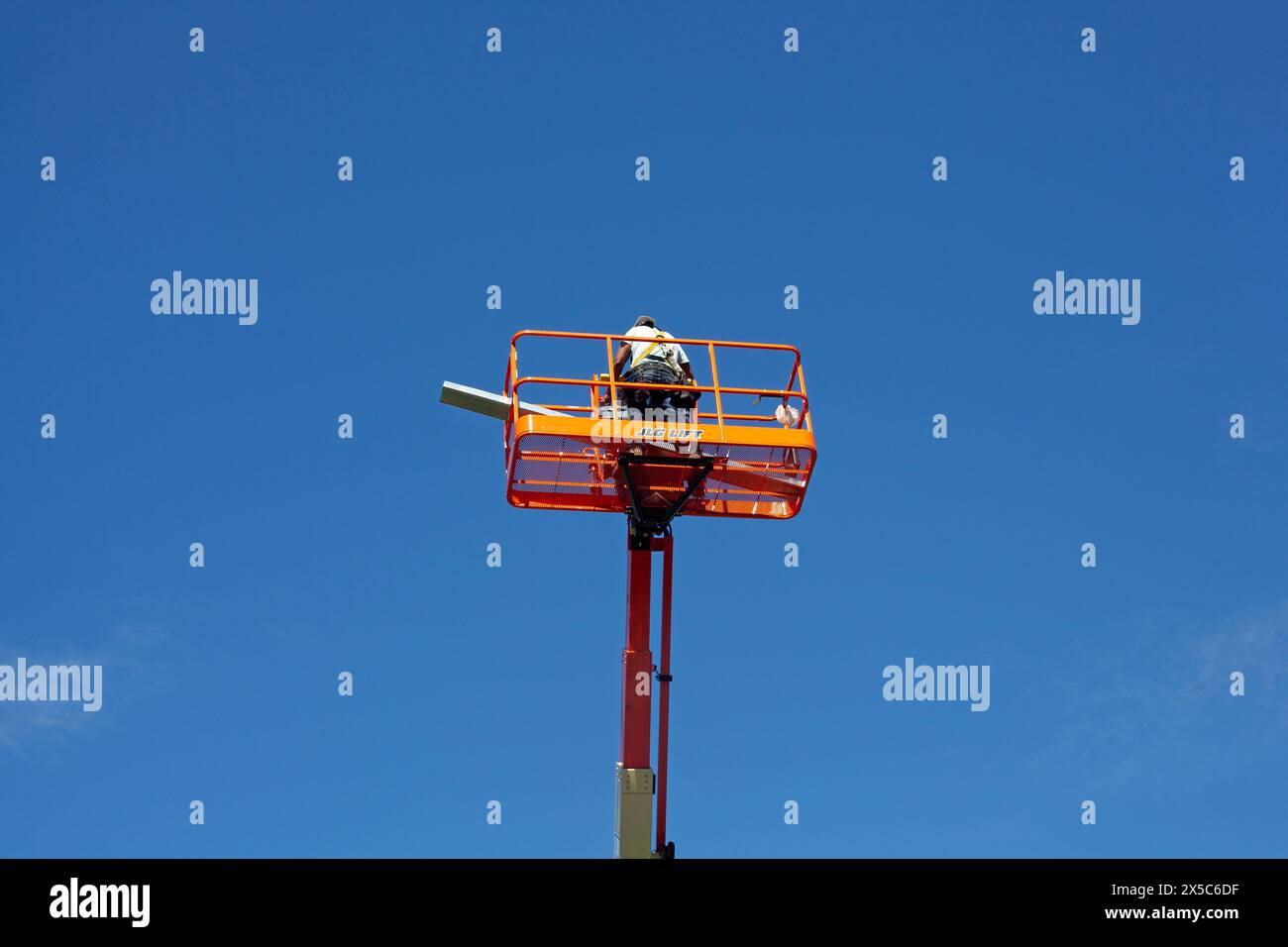 A man goes up in a lift to complete a construction project Stock Photo ...