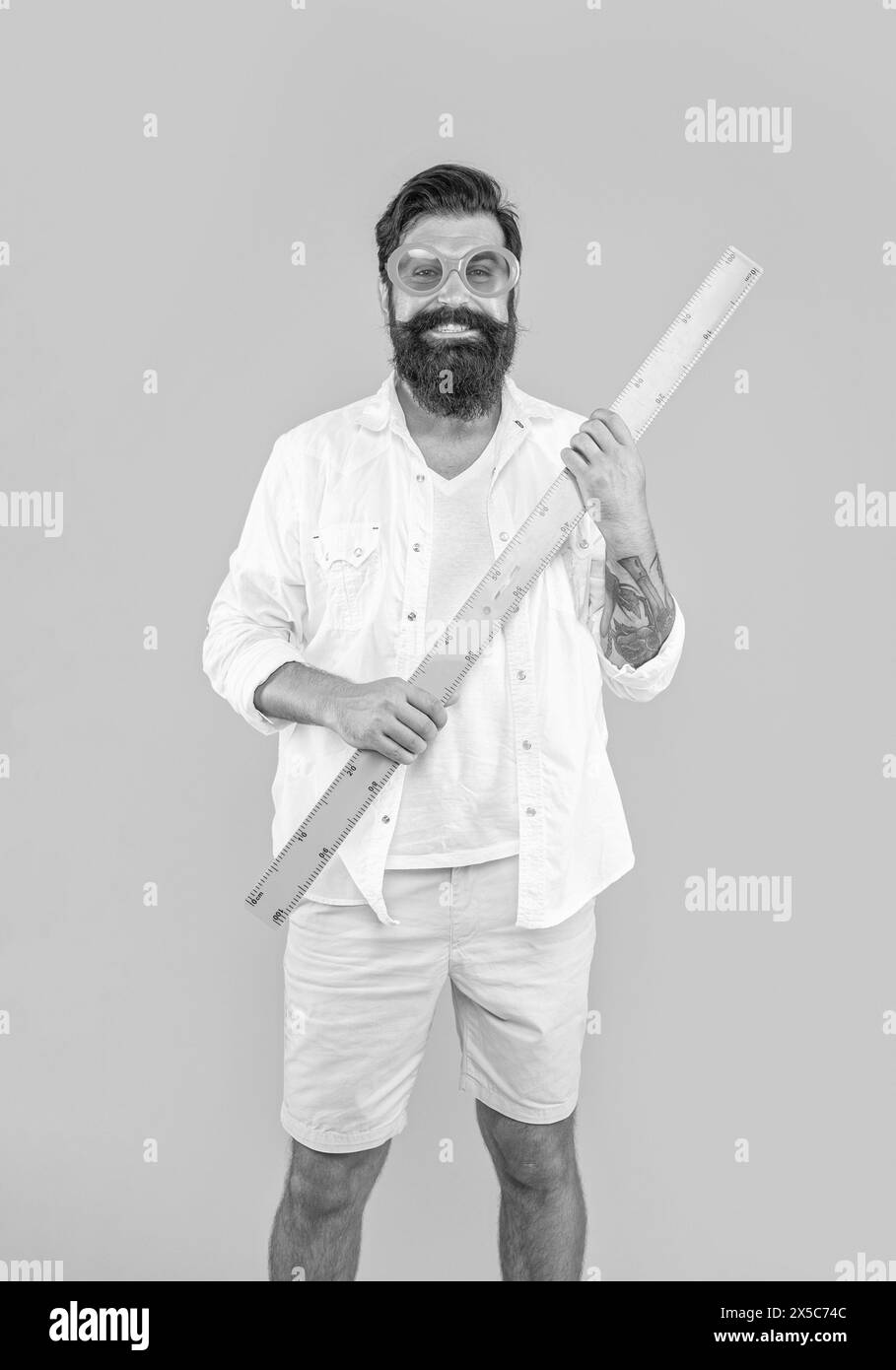 happy man hold measuring ruler in studio. man hold measuring ruler on ...