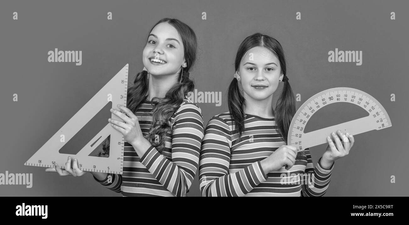 smiling school students hold math tool of triangle and protractor Stock ...