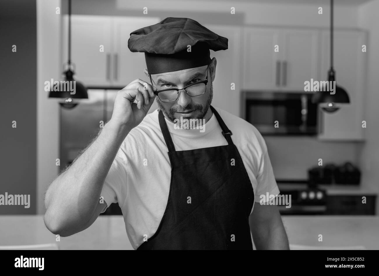 Handsome middle age man in chef uniform at kitchen. Cooking and ...