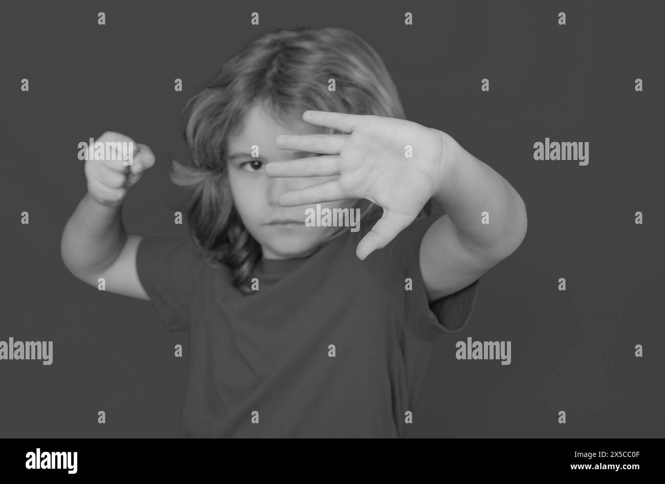 Kid in red t-shirt making stop gesture on isolated studio background ...