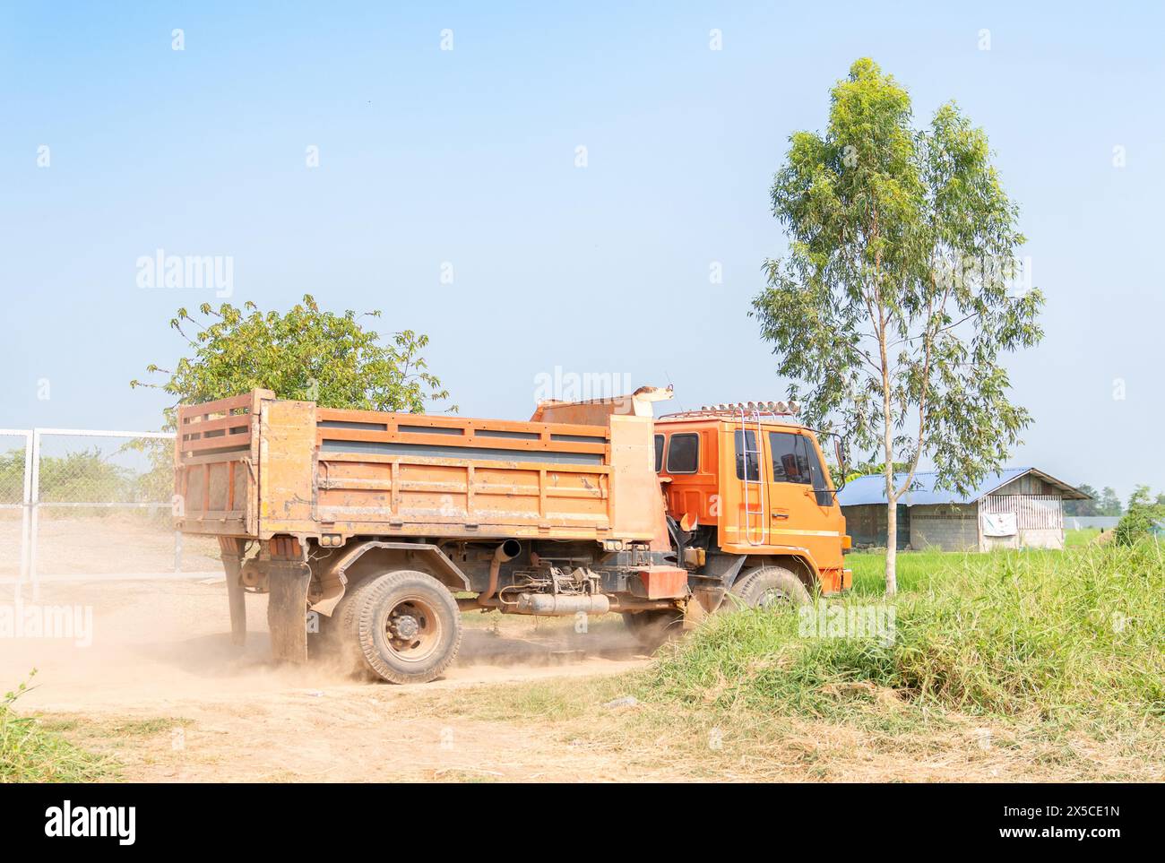Dump truck carrying soil moving on road in local country Stock Photo ...