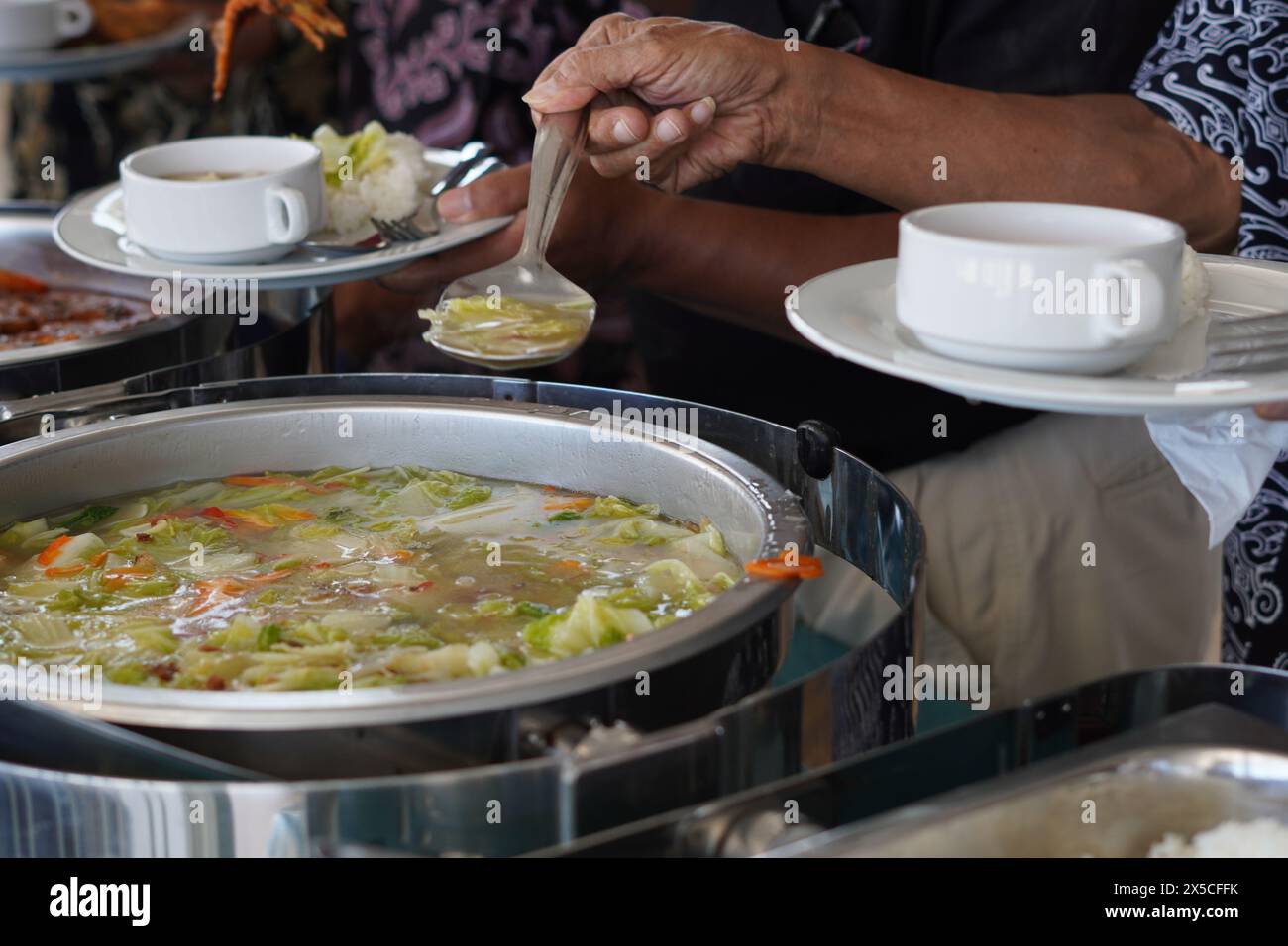 People taking food from a buffet at an event in Indonesia Stock Photo ...