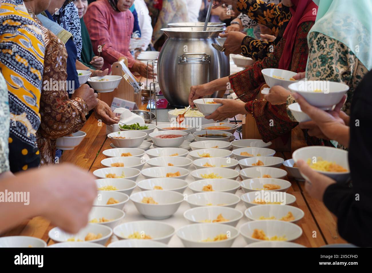 People taking food from a buffet at an event in Indonesia Stock Photo ...