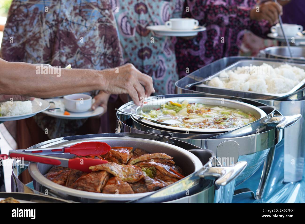 People taking food from a buffet at an event in Indonesia Stock Photo ...