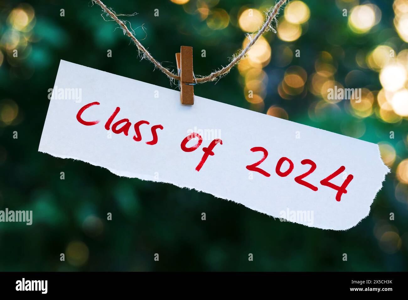 class of 2024 on pink note paper hanging on rope with bokeh background Stock Photo - Alamy