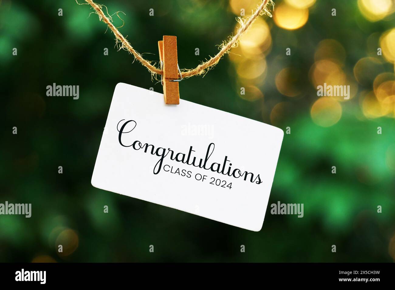 Senior class of 2024 on a note paper hanging on rope with bokeh ...